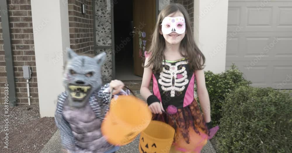 Two young children, a boy and a girl, dressed in werewolf and day of ...