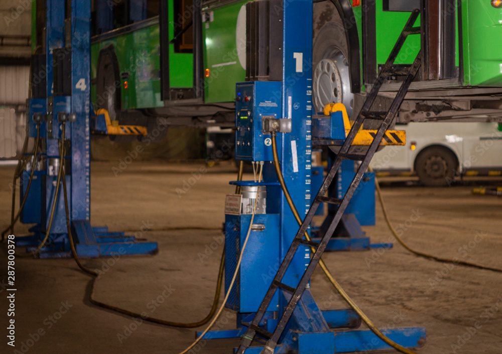 Maintenance and repair of large buses using mobile elevators Stock ...