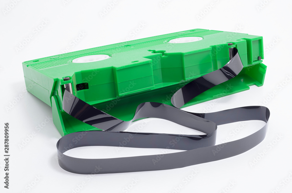 VHS Tape With Open Cover And The Magnetic Tape Rolled Out Of The Spool 