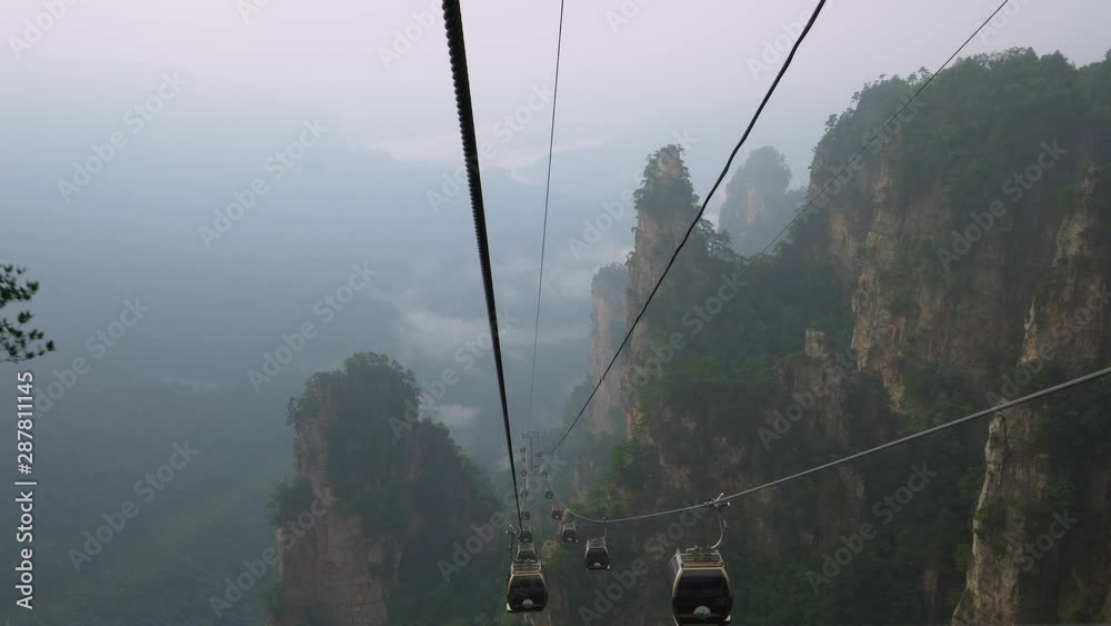 Famous touristic attraction. A cable car up to Huangshizhai crossing ...