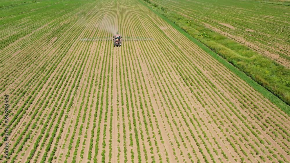 Tractor with pesticide fungicide insecticide sprayer on farm land, top ...