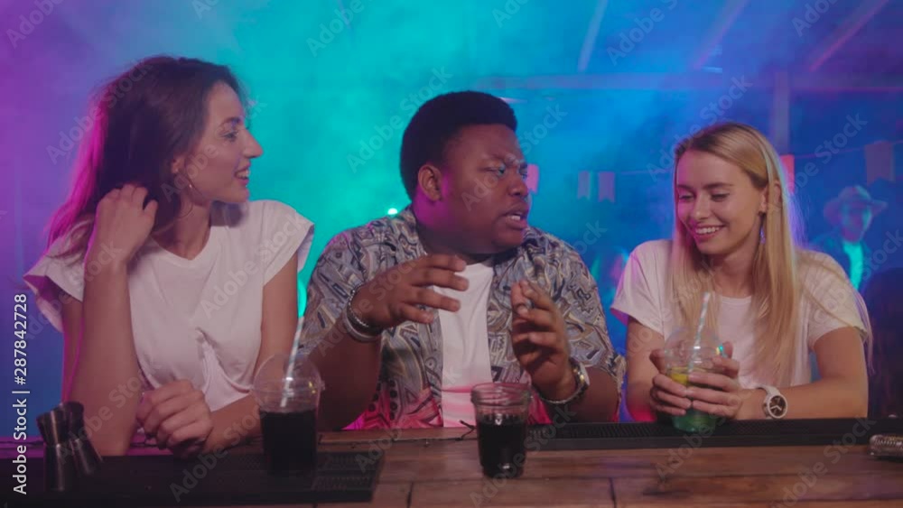 Group of happy friends hanging out together at club party. Handsome boy ...