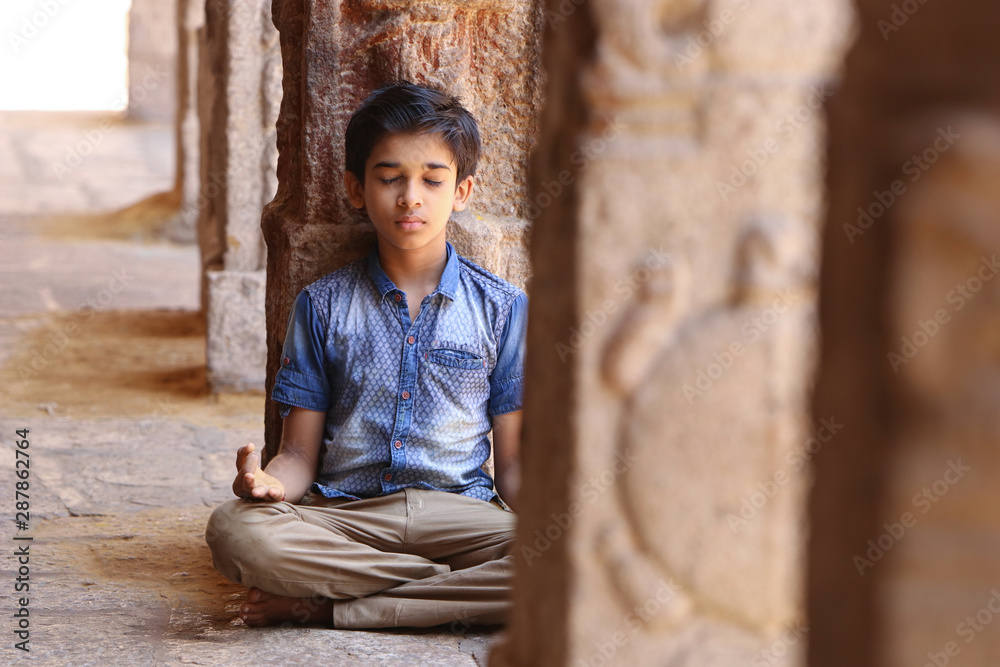 Indian young boy meditating at hindu temple Stock Photo | Adobe Stock