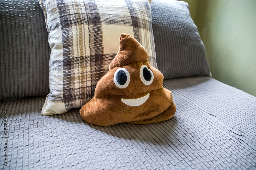 Poster Bed with gray bedding and decorative pillow with poop emoticon ...