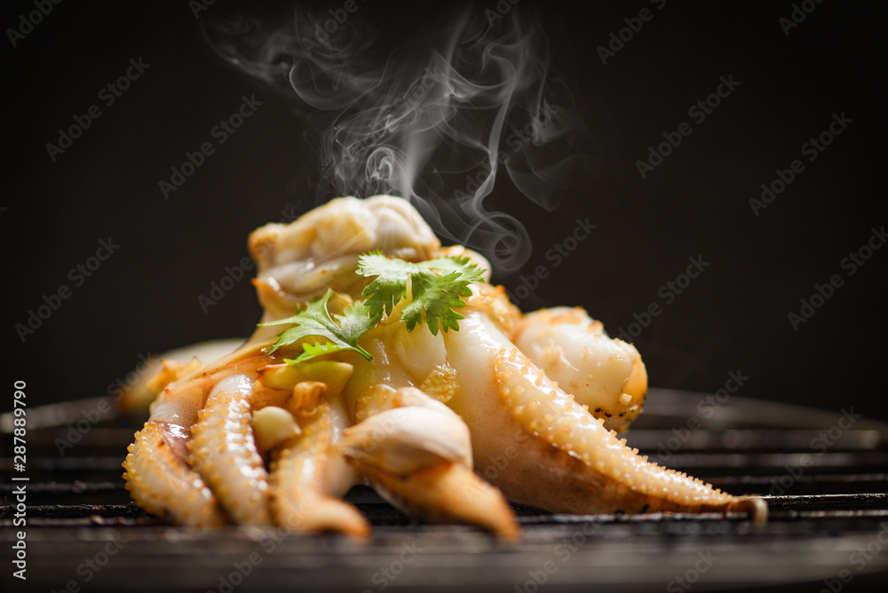 grilled octopus on grill seafood bbq with herbs and spices on dark ...