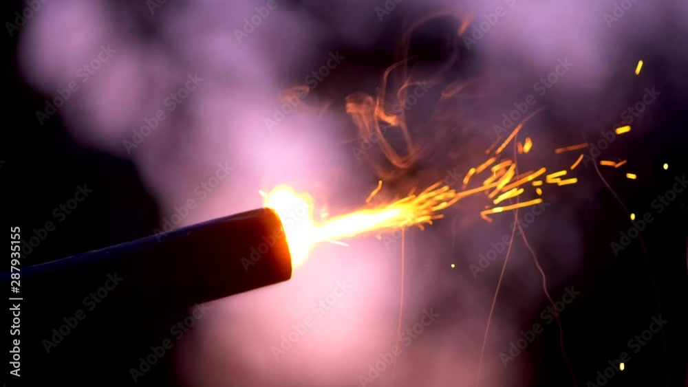 Signal flare ignition. Fire and sparks of red signal flare over dark ...