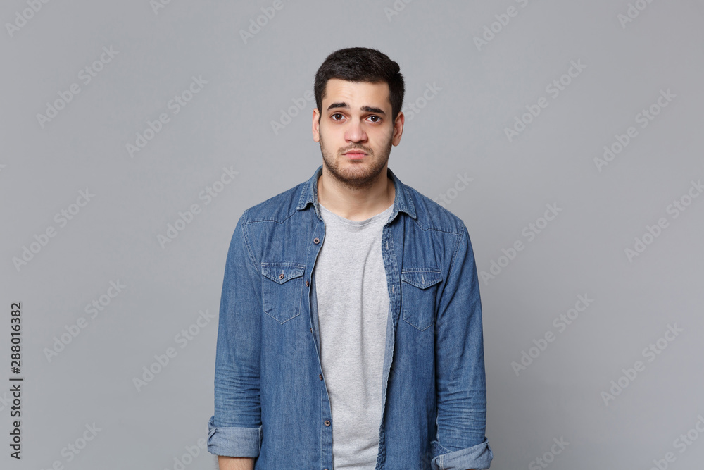 Handsome stylish unshaven young man in denim jeans shirt posing ...