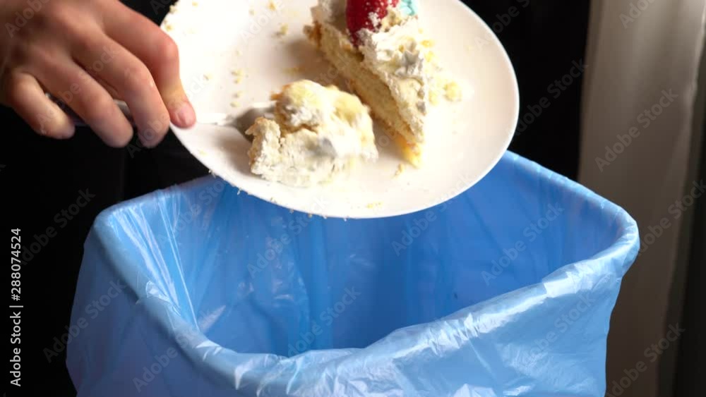 Food Waste Reduction. Throwing away dessert in the trash. Leftovers ...