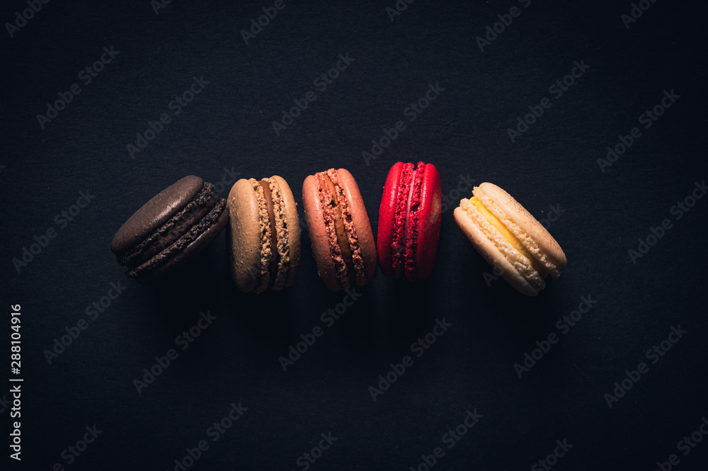 macaroons on black colour background Stock Photo | Adobe Stock