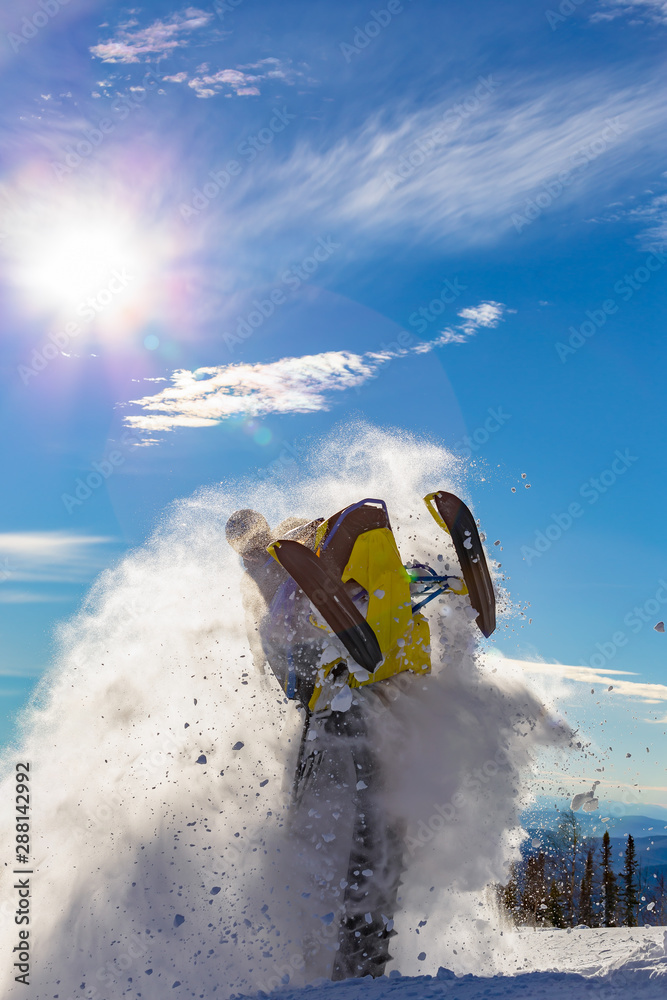 snowmobile jump. bright snowmobile in motion. the guy is flying on a ...