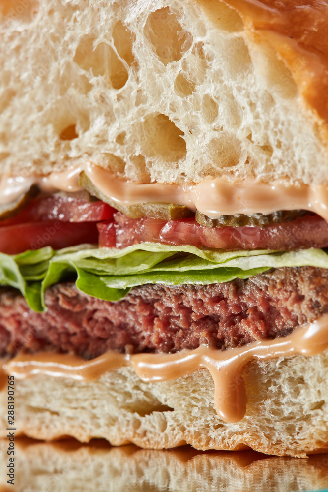 Macro view of tasty grilled beef burger incision background with ...