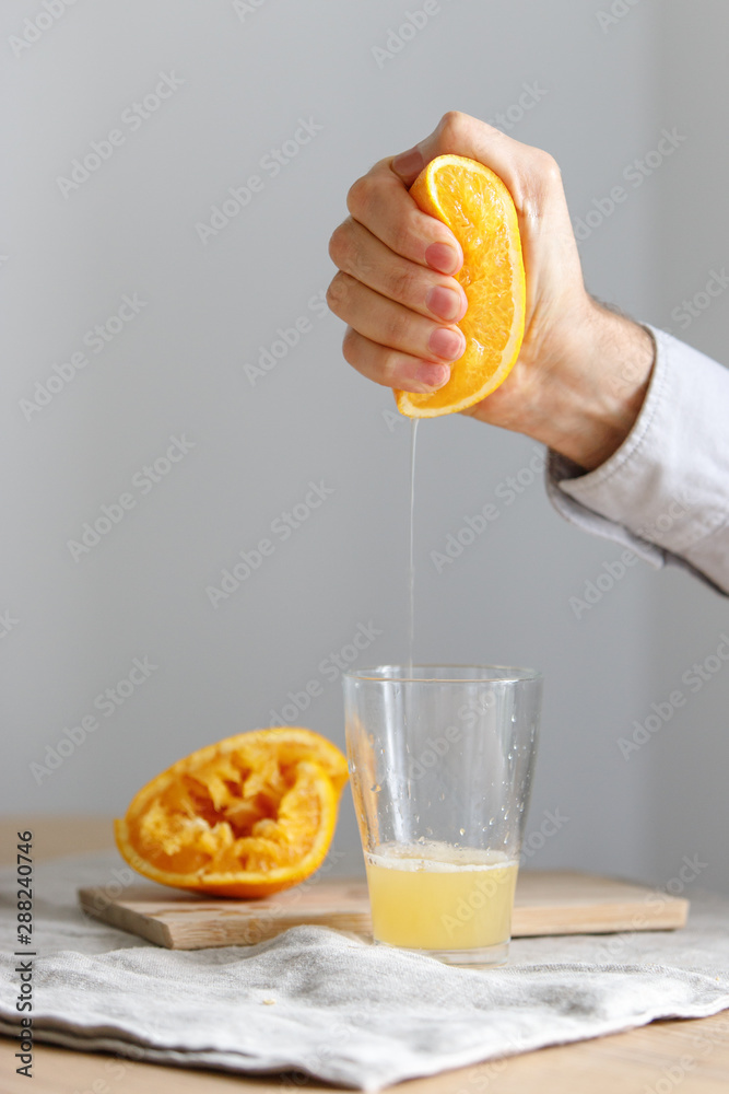 Hand squeezed orange juice, grey background. Vitamin C is vital for ...
