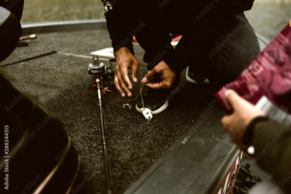 Foto de From above hands of fishermen stringing wobblier on fishing ...