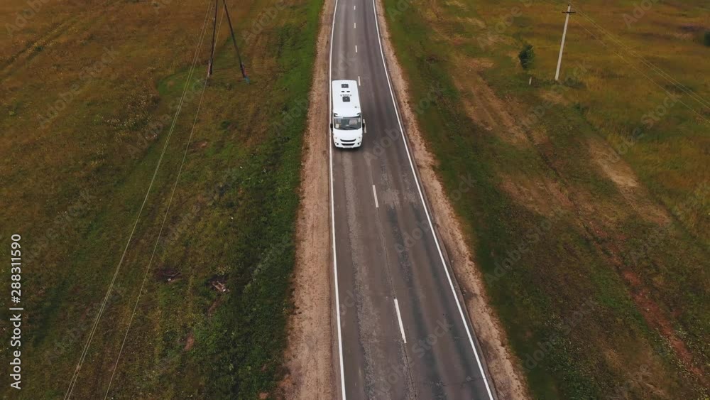 white bus drives along asphalt road with marking aerial Stock Video ...