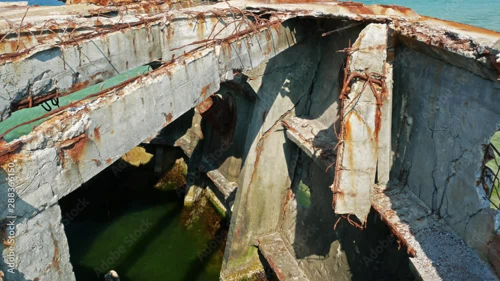 Panorama of a part of an abandoned shipwreck. A calm sea and a bright ...