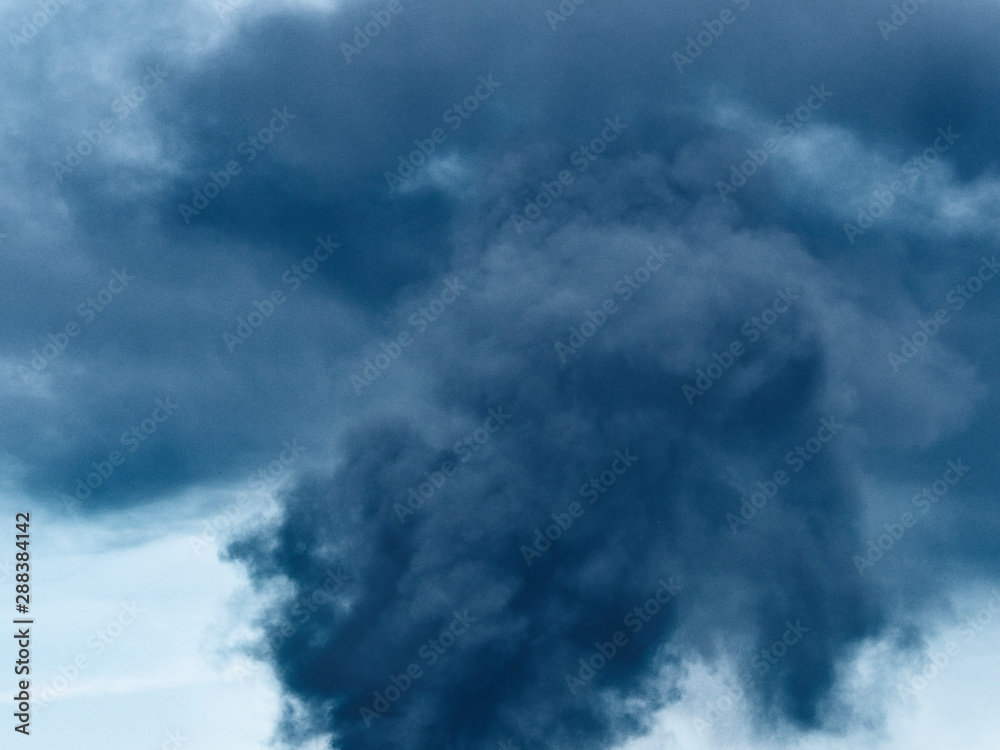 A Burning plastic recycling place causes a big pile of dark, black ...