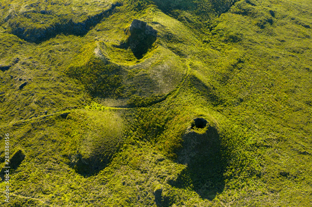Aerial image of typical green volcanic caldera crater landscape with ...