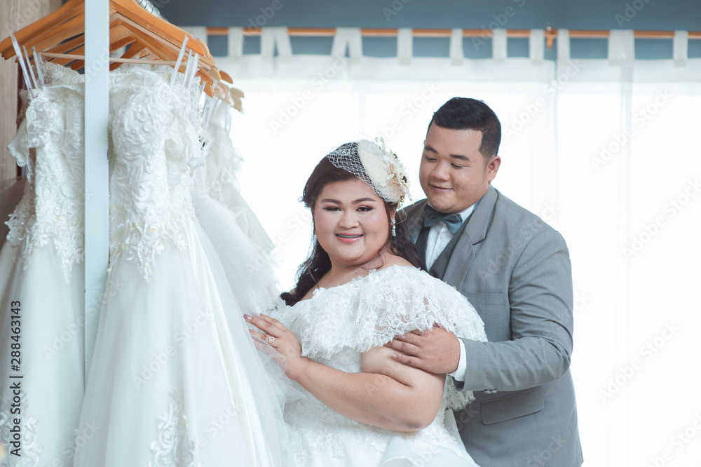 Happy overweight wedding dress and tuxedo or plus size newlywed or ...