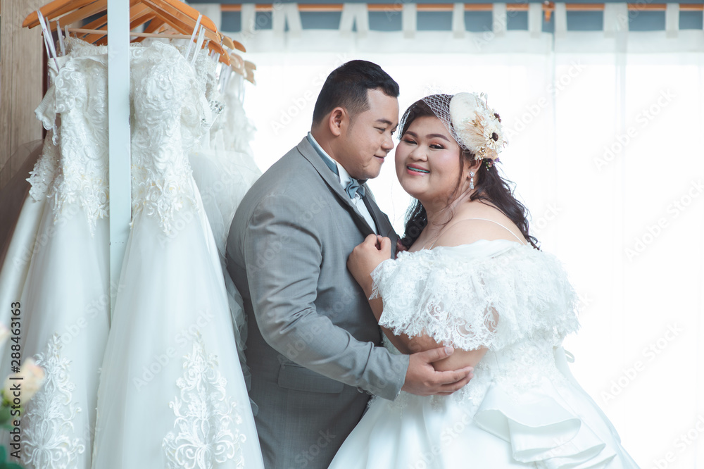 Happy overweight wedding dress and tuxedo or plus size newlywed or ...