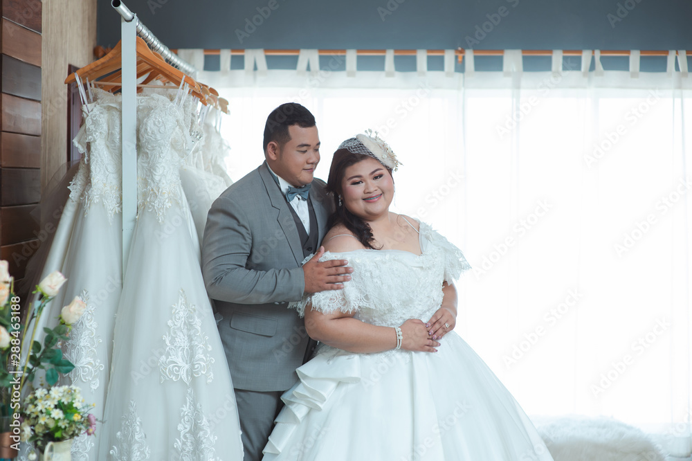Happy overweight wedding dress and tuxedo or plus size newlywed or ...