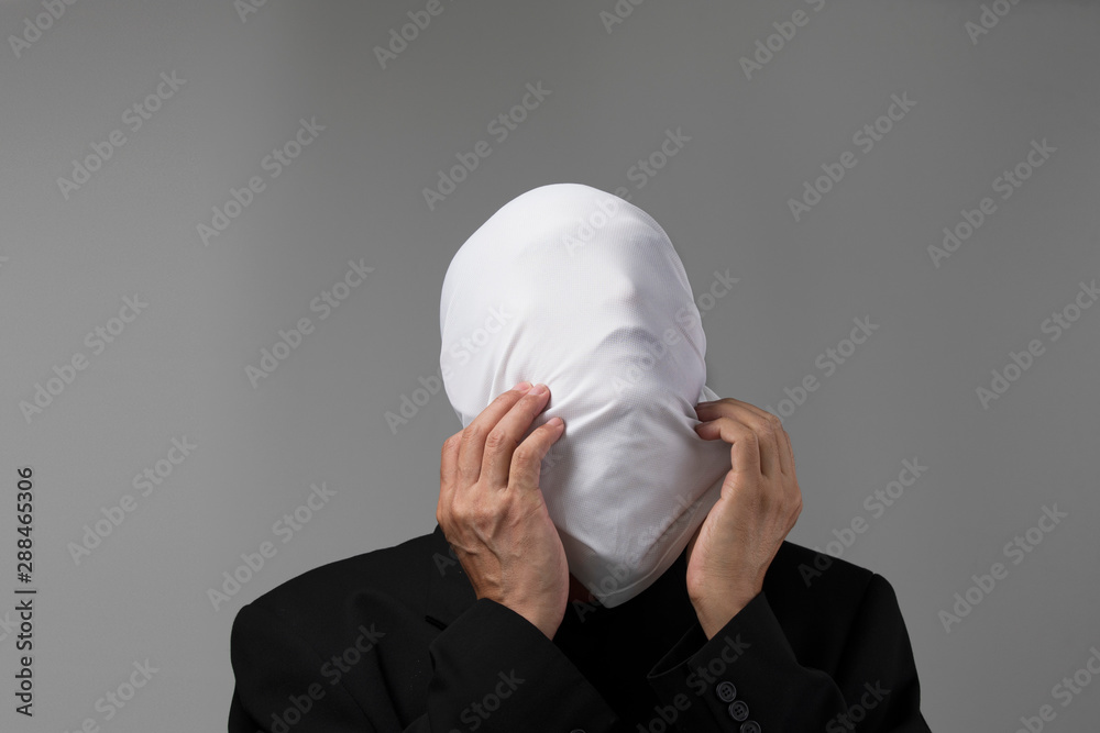 Man covering his face with white mask Stock Photo | Adobe Stock