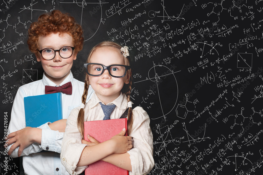 Smart kids portrait. Little girl and boy student holding books and ...