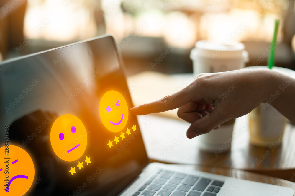 Businesswoman pressing face emoticon on the laptop.Asian woman pressing ...