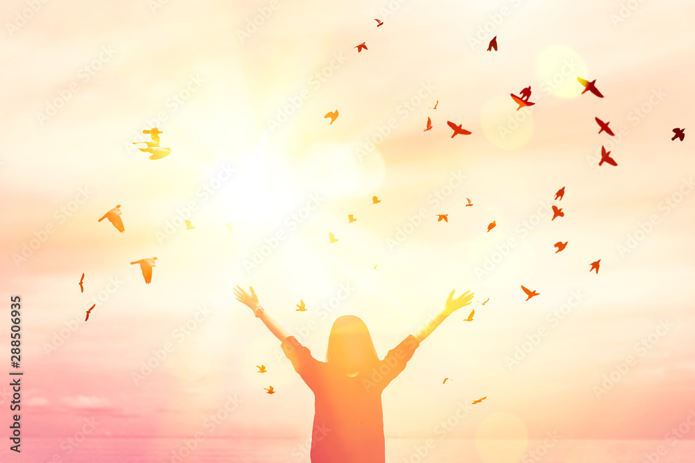 Copy space of woman raise hand up on sunset sky at beach and island ...
