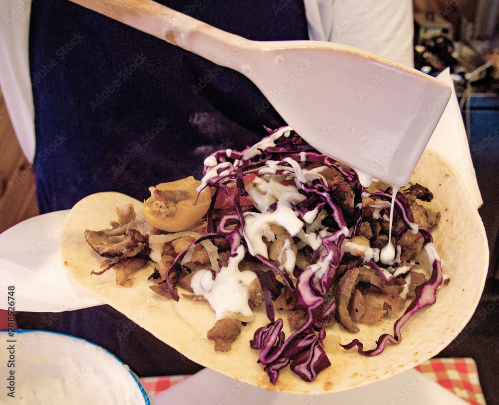 italian street food, piadina filled with pork and salad seasoned with ...