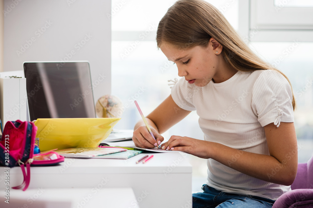 Concentrated school girl write and draw right hand Stock Photo | Adobe ...