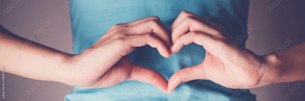 Woman hands making a heart shape on her stomach, healthy bowel ...