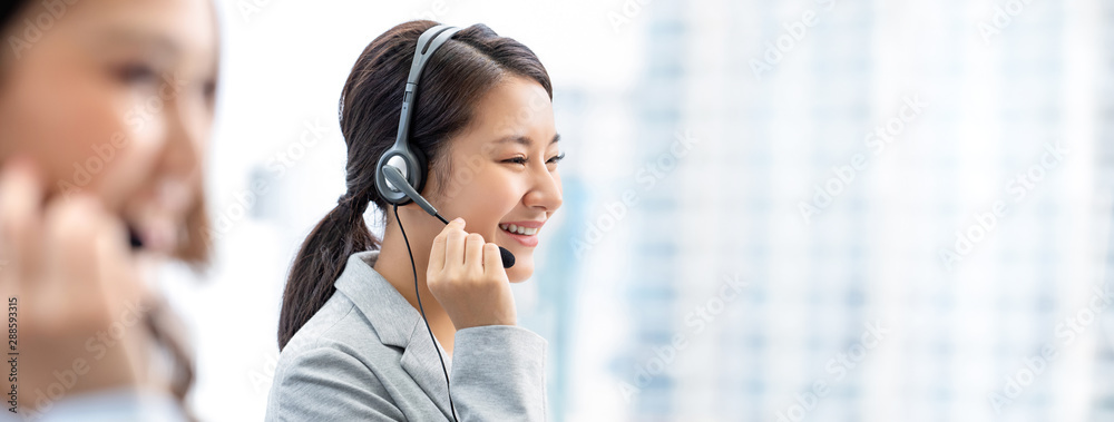 Asian woman working in call center office Stock Photo | Adobe Stock