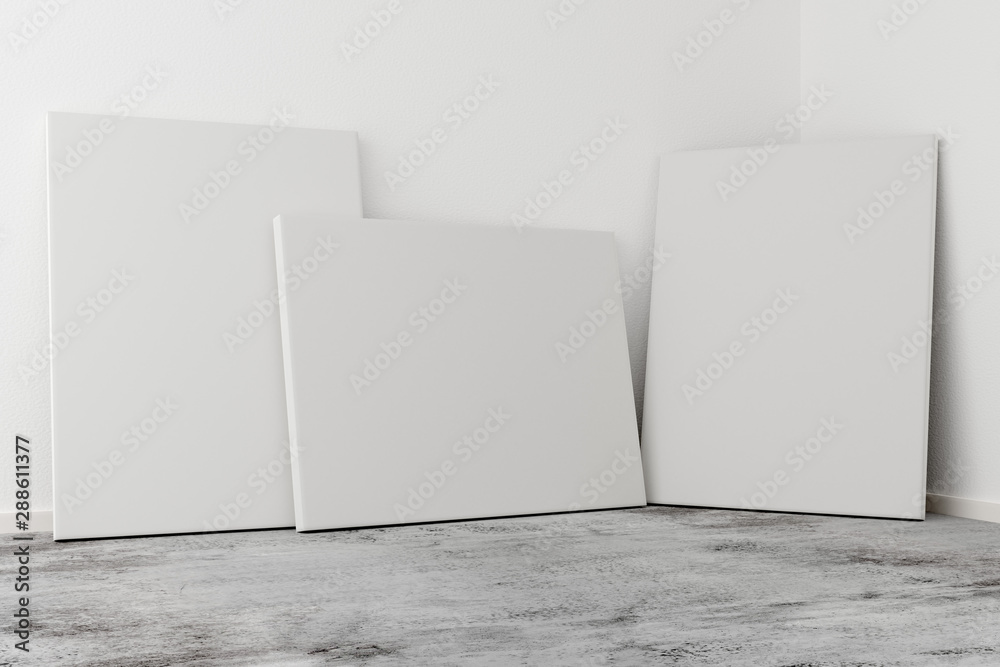 Multiple empty picture frames canvases leaning against white wall in ...