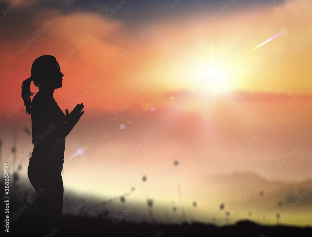 Silhouette faith woman standing and praying on blurred mountain sunset ...