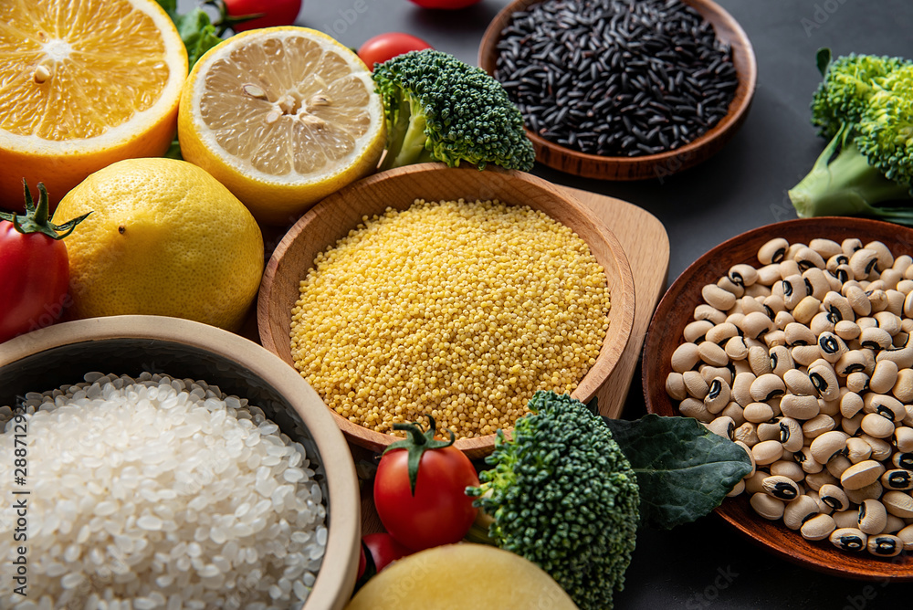 Full screen of fresh seasonal fruits and vegetables and whole grains ...