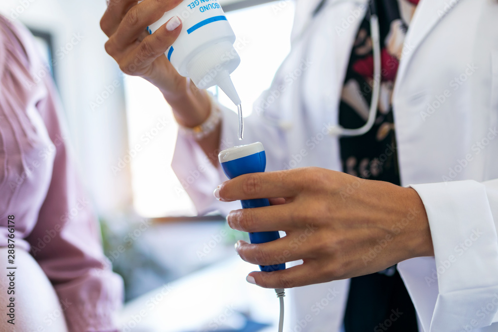 Obstetrician gynecologist performing Doppler auscultation checking ...