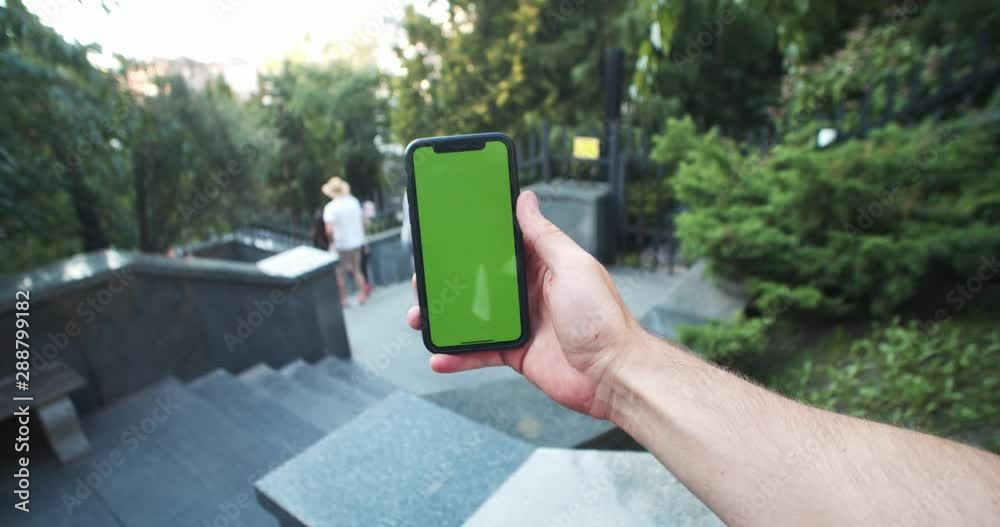 Young man adult holding vertical smartphone interacting mockup ...