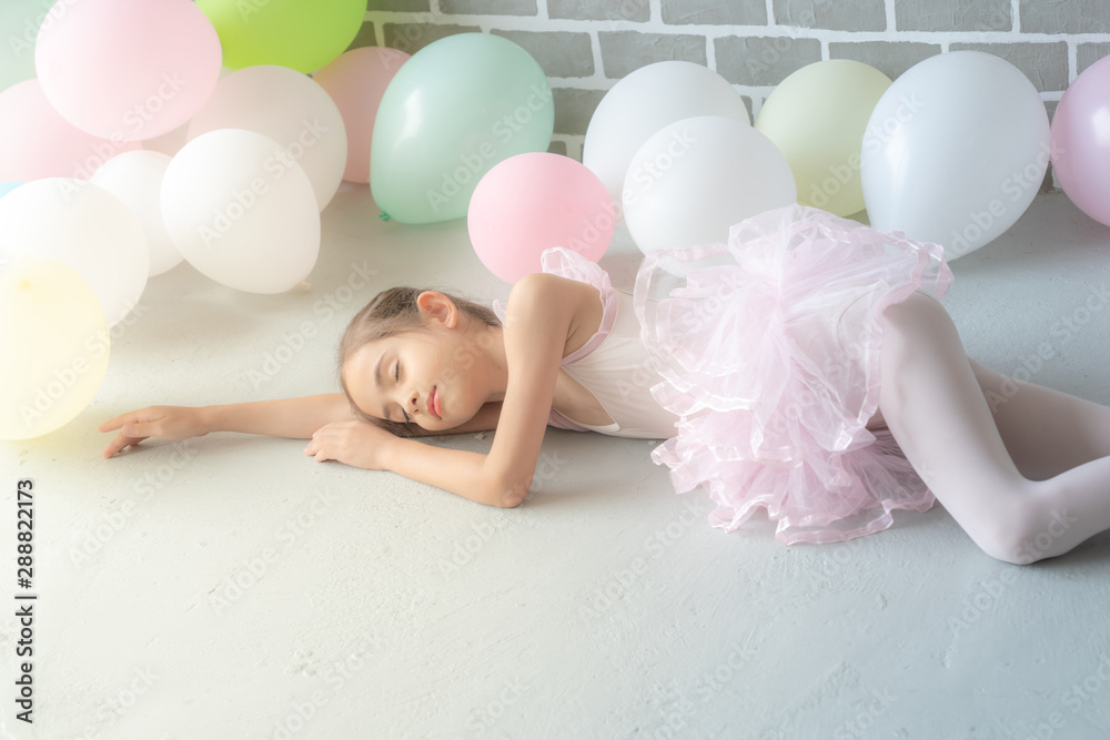 Selective focus of relax little young girl ballet dancer in pink ...