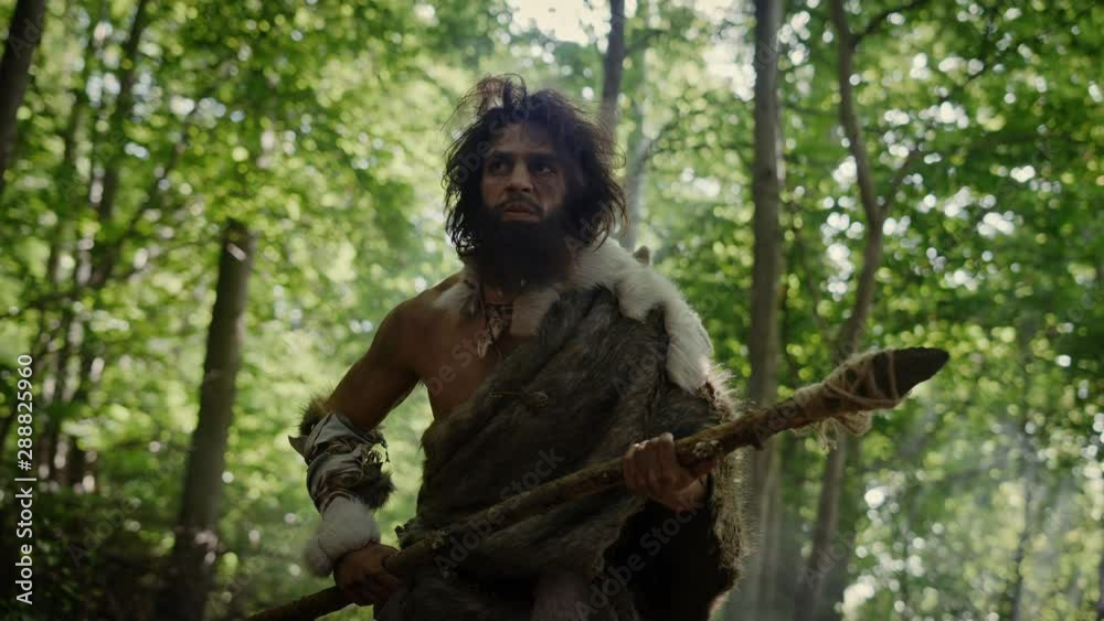Portrait of Primeval Caveman Wearing Animal Skin and Fur Hunting with a ...