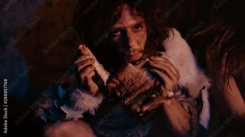 Portrait of Tribe Leader Wearing Animal Skin Eating in a Dark Scary ...