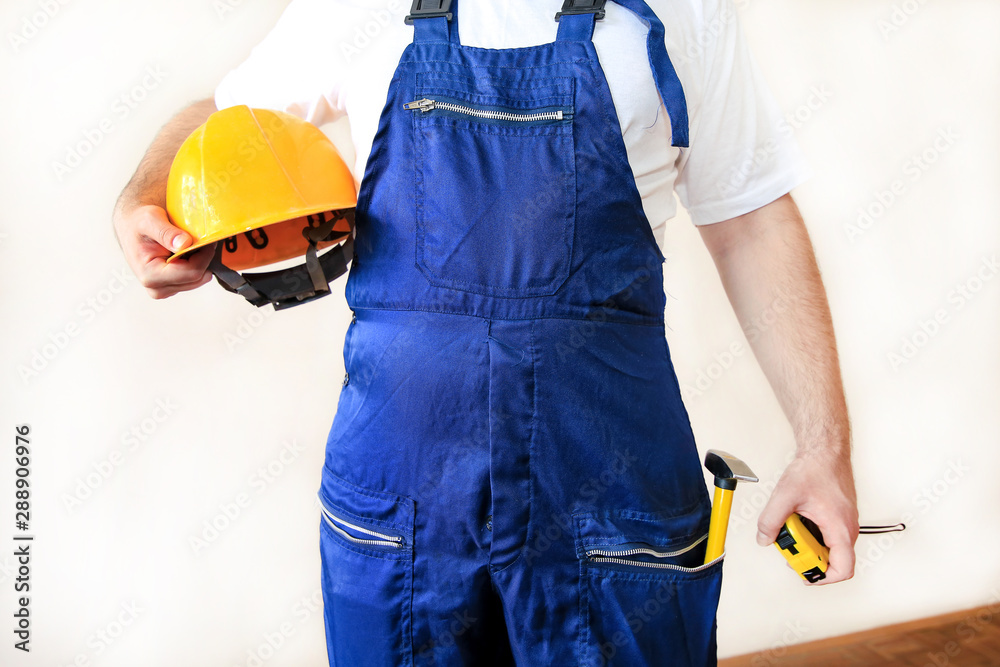 Construction worker at construction site with protective uniform ...