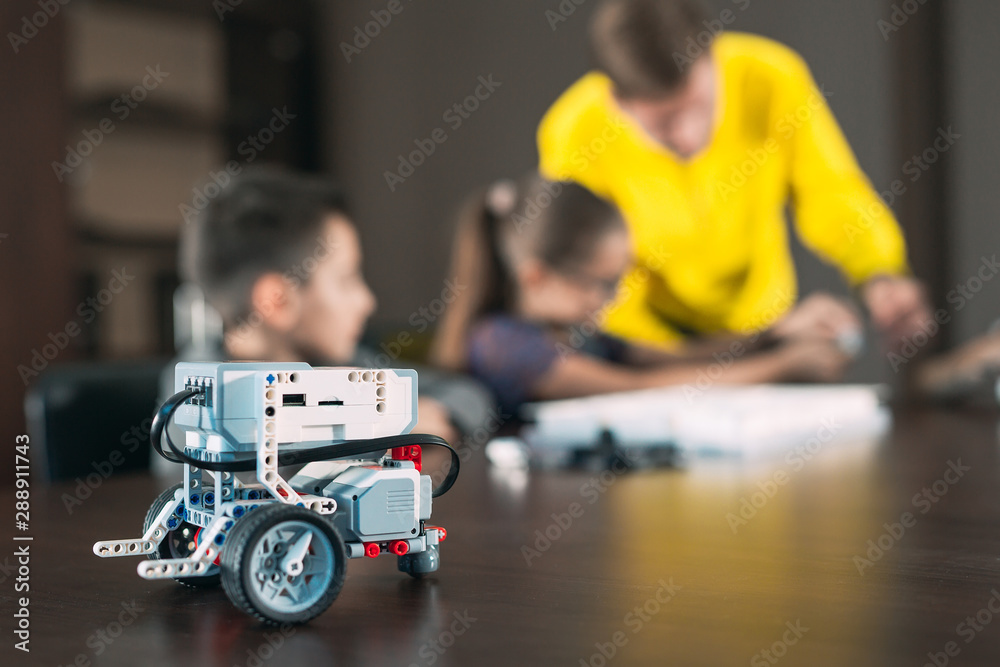Kids creating robots with teacher. Early development, diy, innovation ...