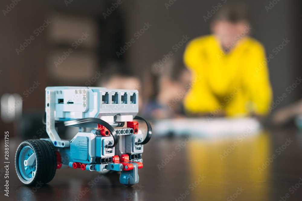 Kids creating robots with teacher. Early development, diy, innovation ...