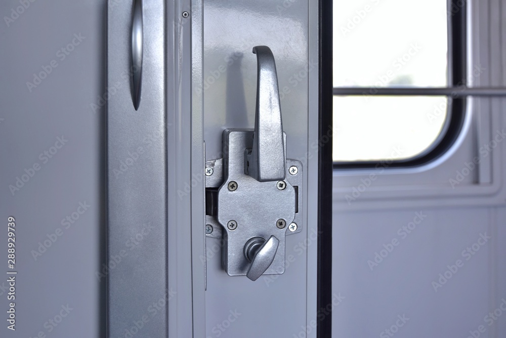 Steel door handle in a train compartment with selective focus and ...