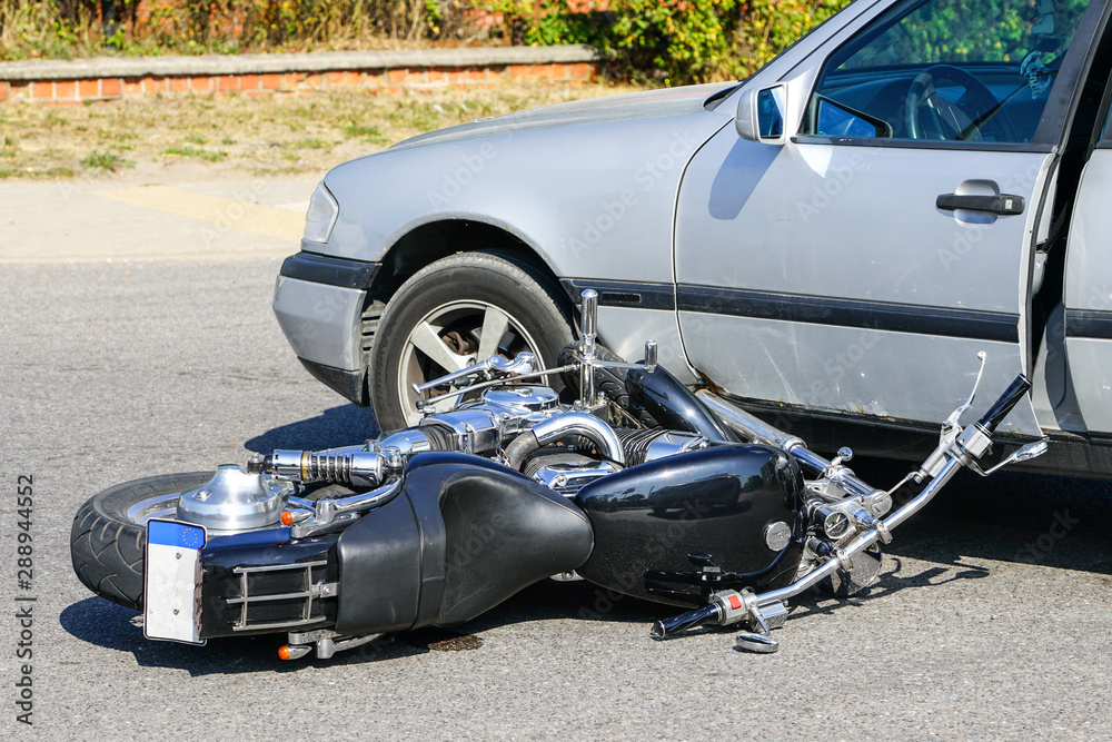 traffic accident, motorcycle collision with a car on city street foto ...