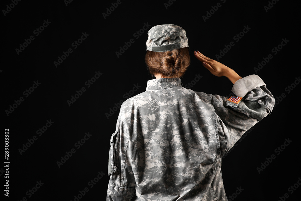 Saluting female soldier on dark background, back view Stock Photo ...