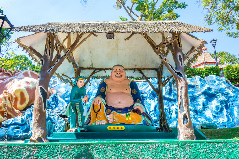 Giant Smiling Buddha statue at Haw Par Villa Theme Park. This park has ...
