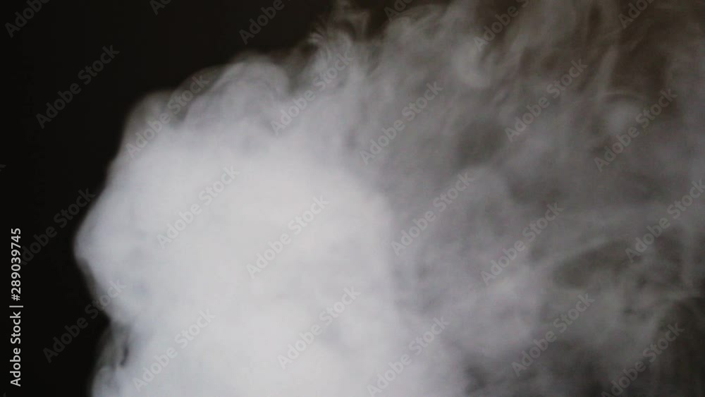 Cloud of exhaled vapor smoke moves across screen as a transition ...