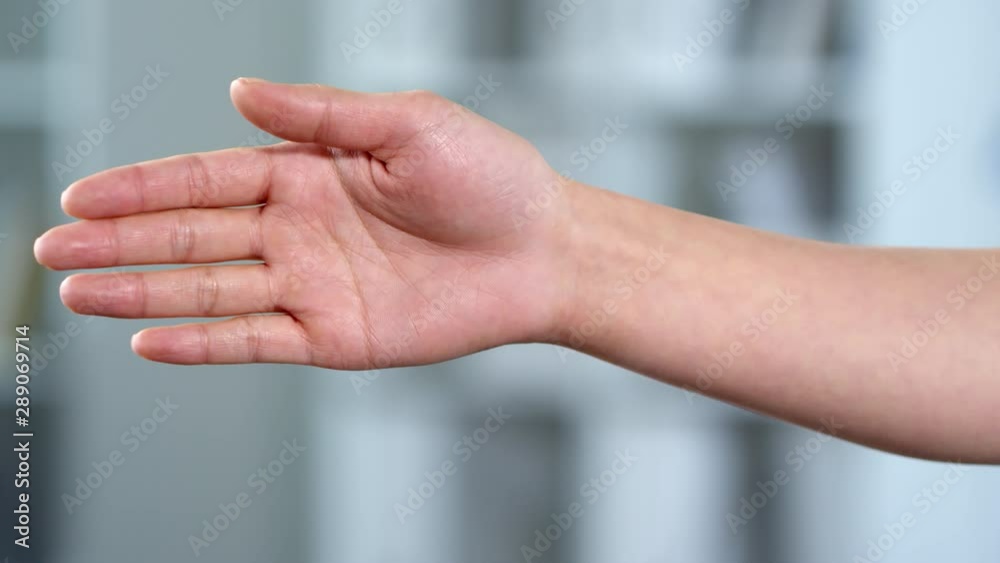 Close-upshot of unrecognizable woman raising bare hand with palm facing ...
