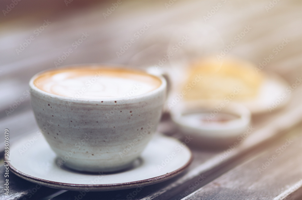Horizontal shot of a cup of coffee. Latte on wooden table in coffee ...